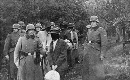 Photo: German security police lead a group of Poles to a site where ...